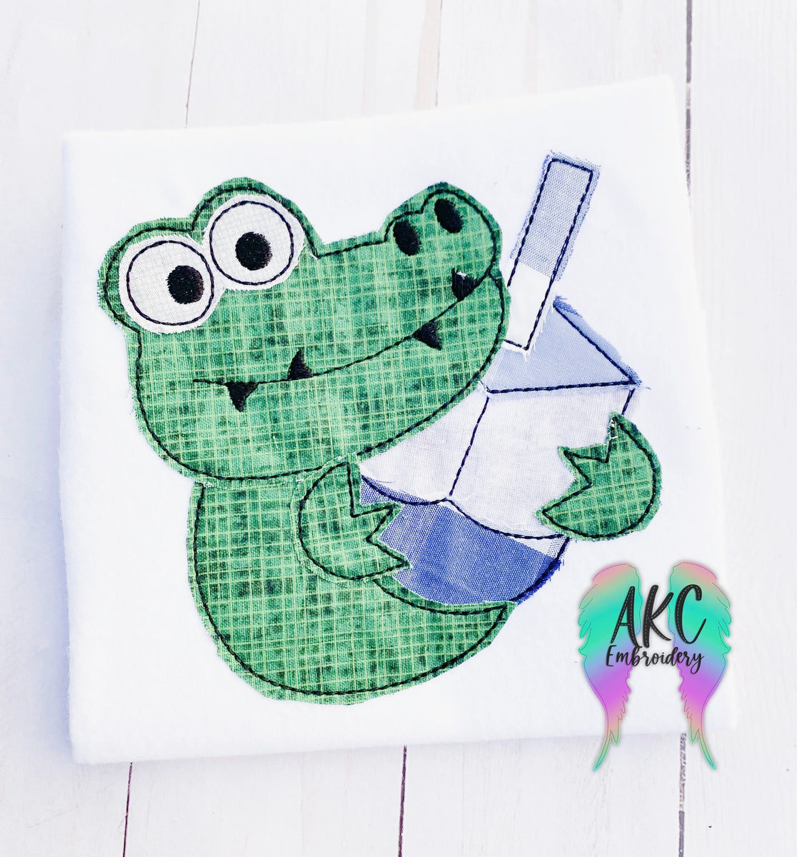 Gator holding dreidel 2022 – AKC Embroidery and Digital Designs