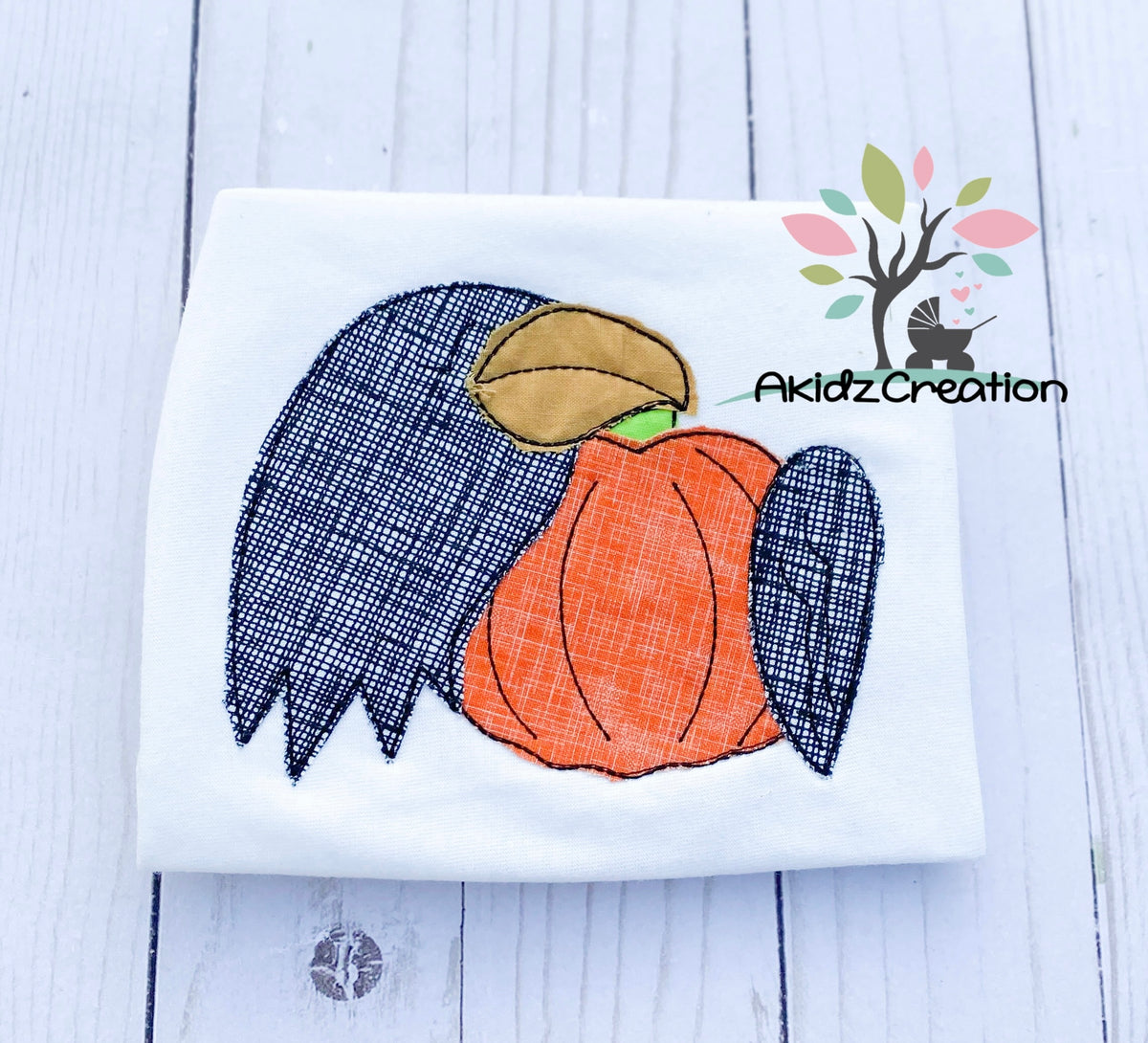 Raven hugging pumpkin 2022 – AKC Embroidery and Digital Designs